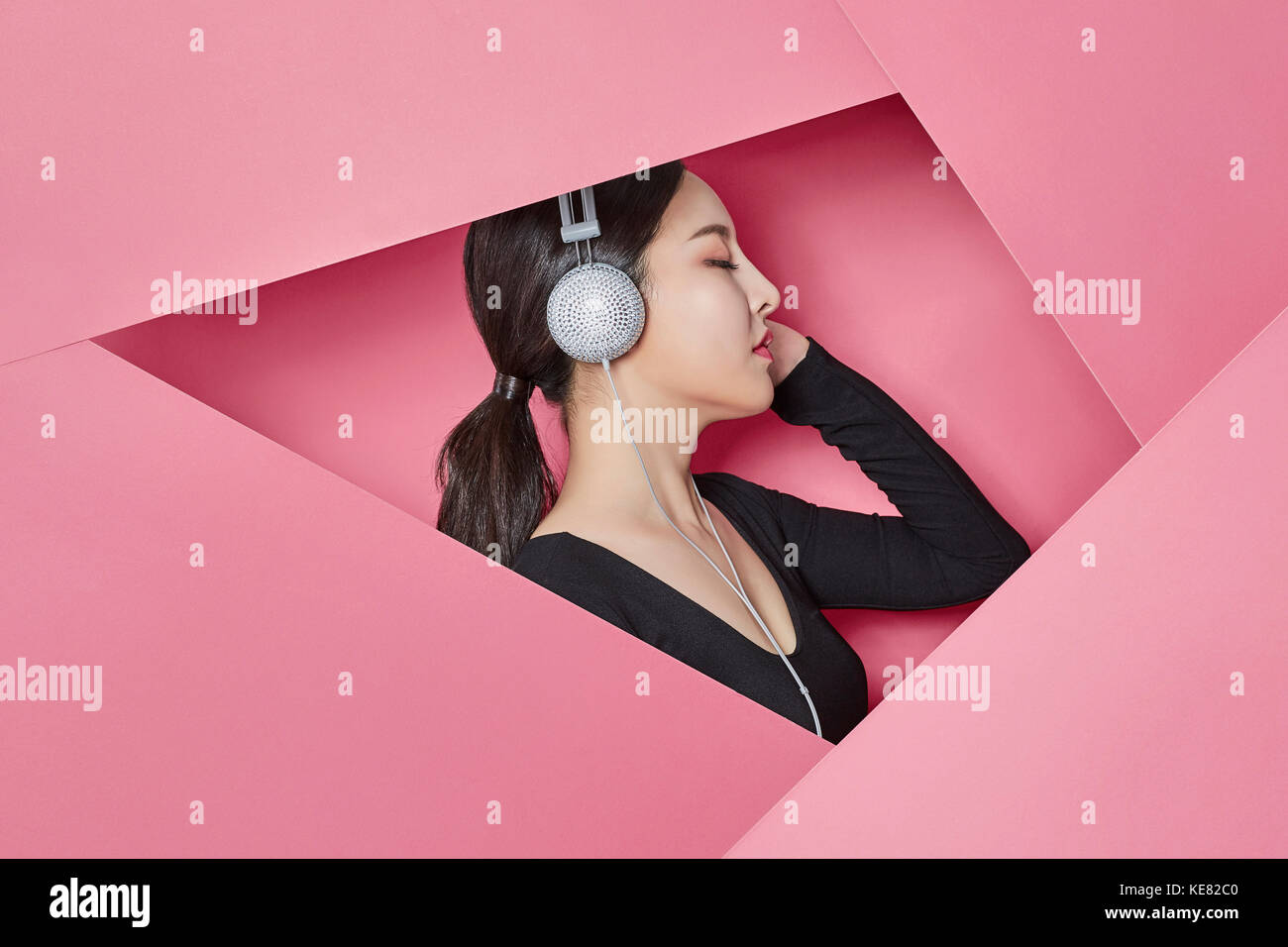 Side view portrait of young woman listening to music closing her eyes ...