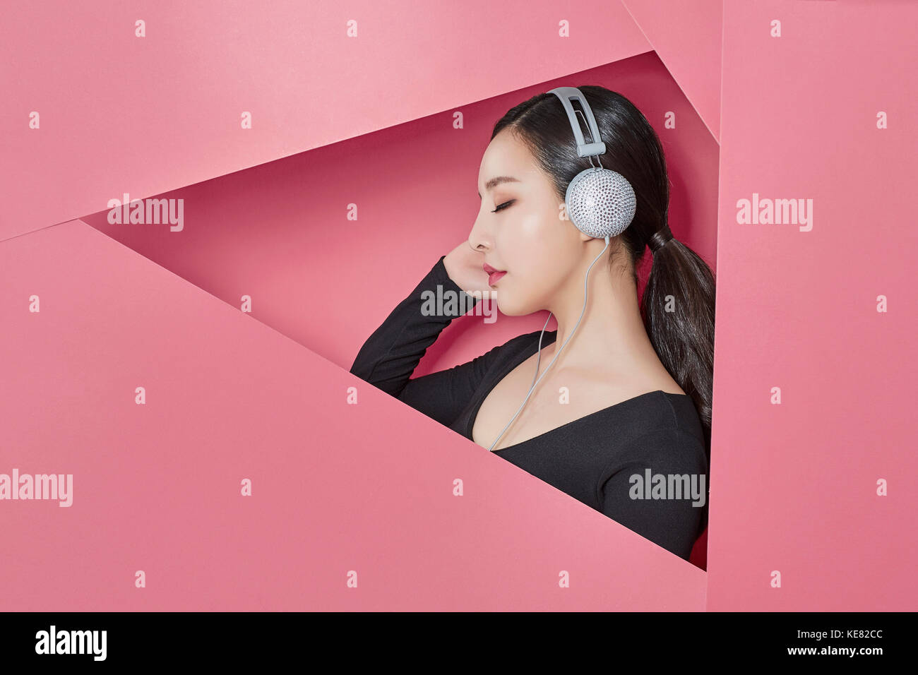 Side view portrait of young woman listening to music closing her eyes ...