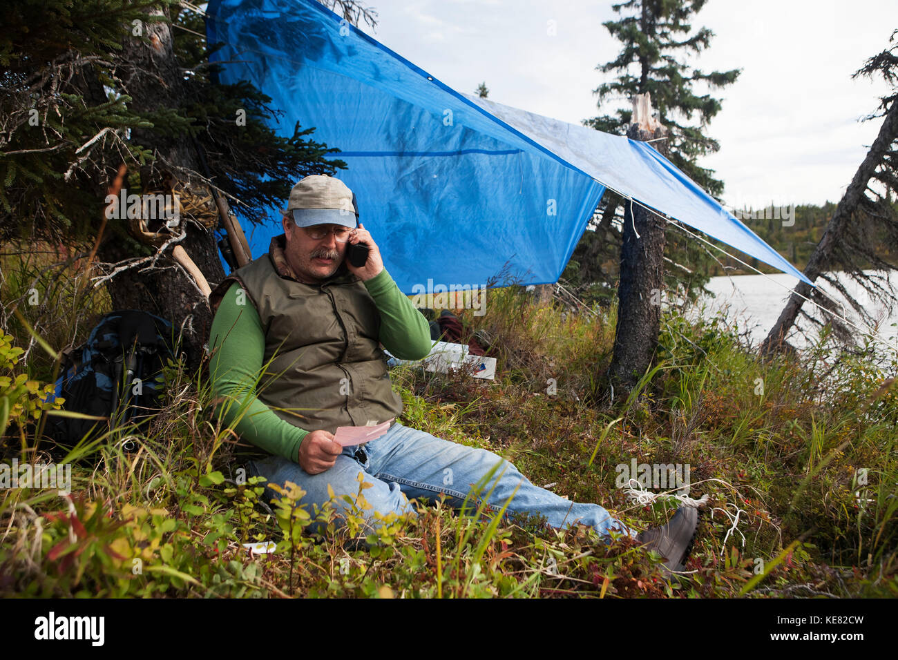 Hunter Talks On A Satellite Phone During A Remote Moose Hunt, Lake ...