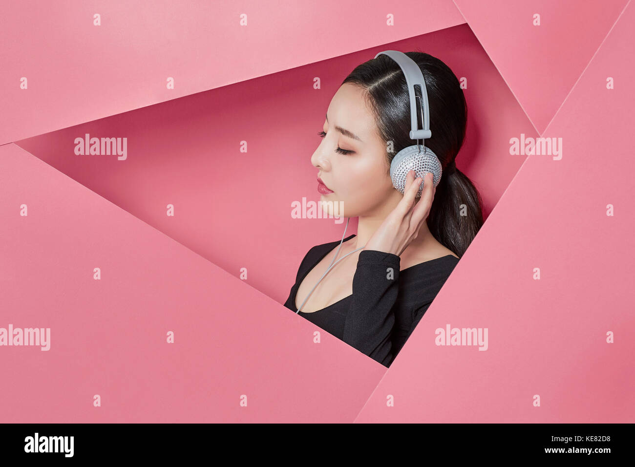 Side view portrait of young woman listening to music closing her eyes ...