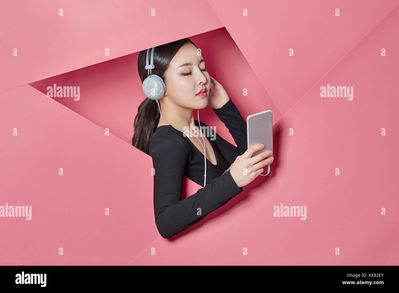 Side view portrait of young woman listening to music closing her eyes ...
