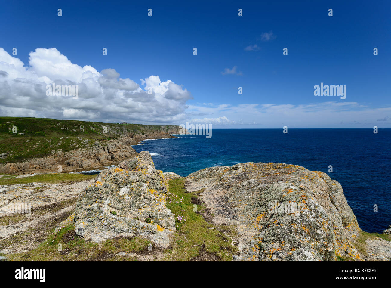 Granite rock formations on cliffs above Porth Loe cove and looking out ...
