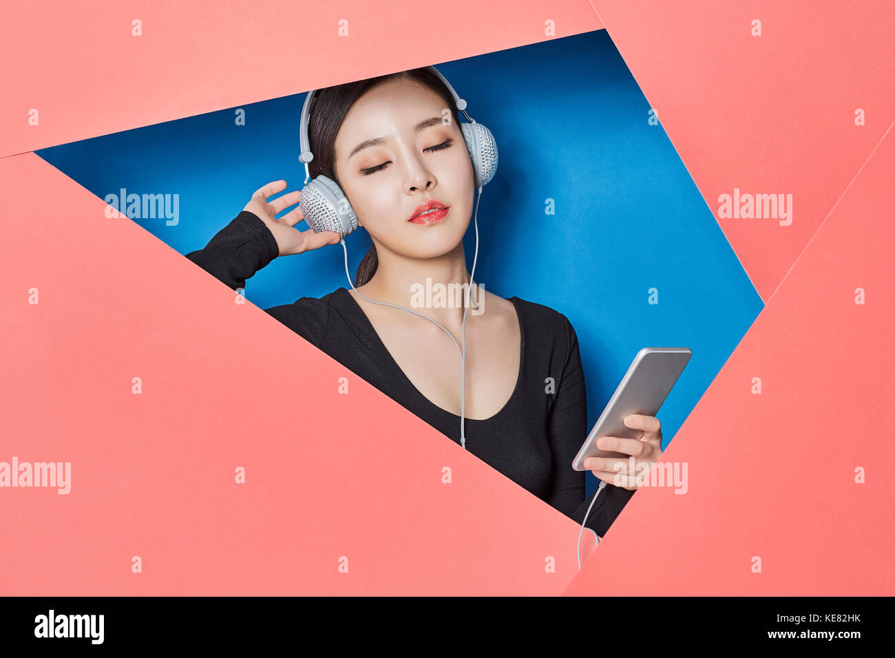 Portrait of young woman listening to music closing her eyes Stock Photo ...