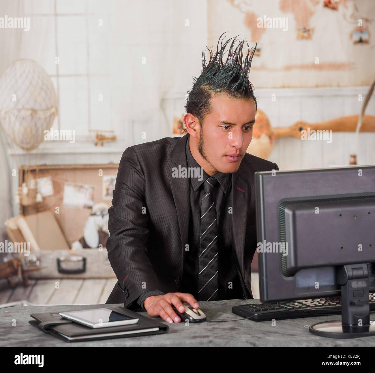 Close up of office punk worker wearing a suit with a crest, working in ...