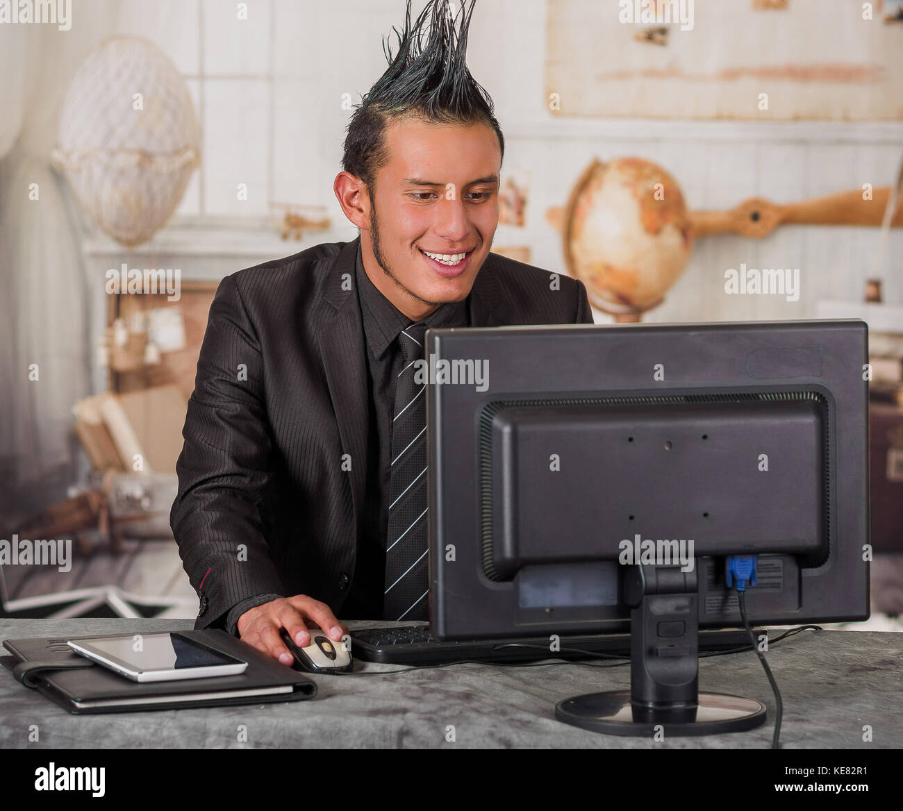 Close up of smiling office punk worker wearing a suit with a crest ...