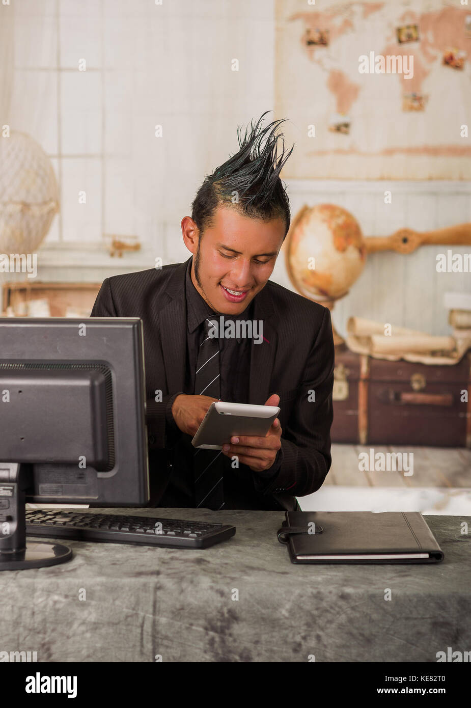 Close up of office punk worker wearing a suit with a crest, using his ...