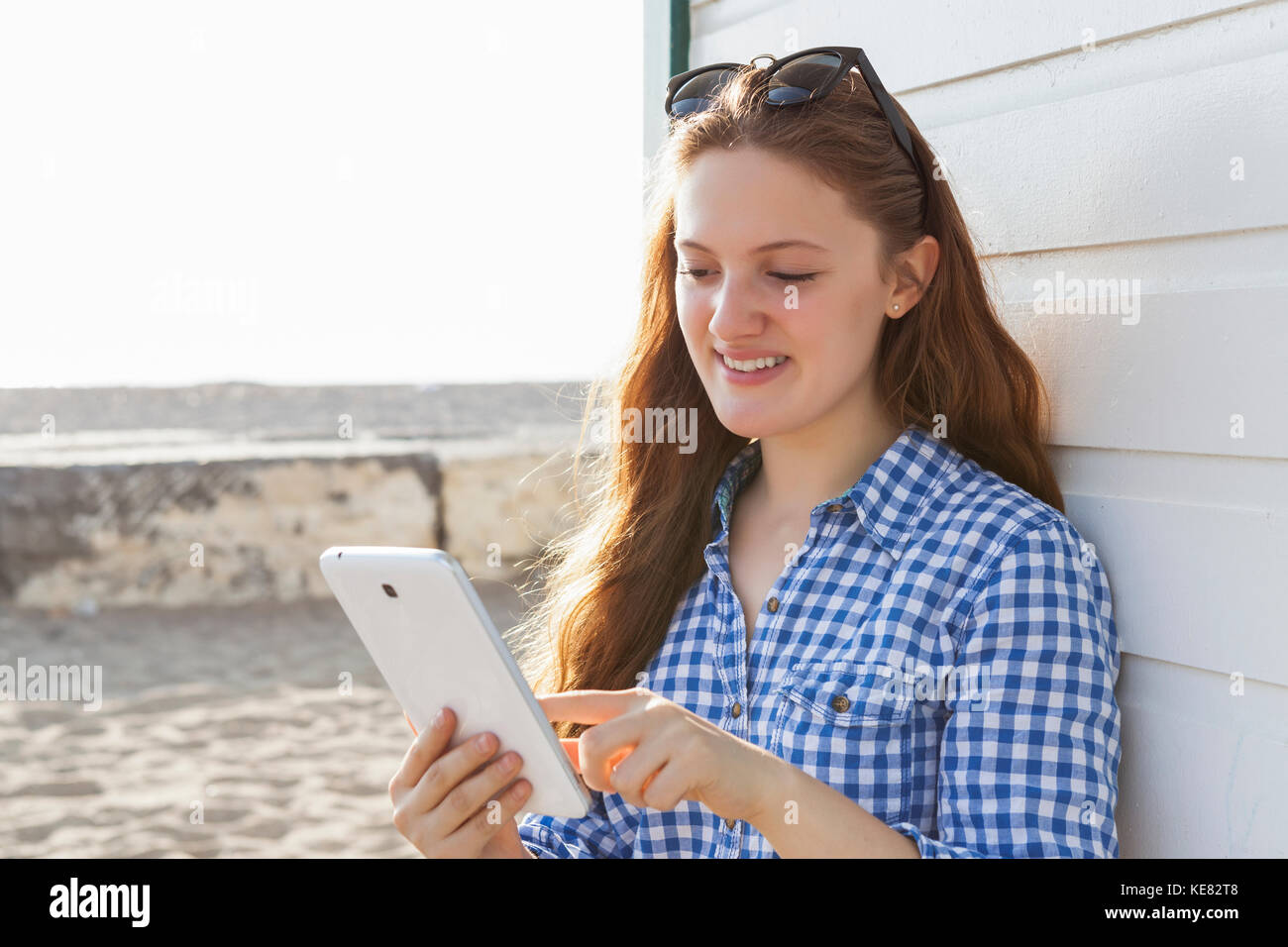 Girl using tablet at Woodbine beach in summer; Toronto, Ontario, Canada ...