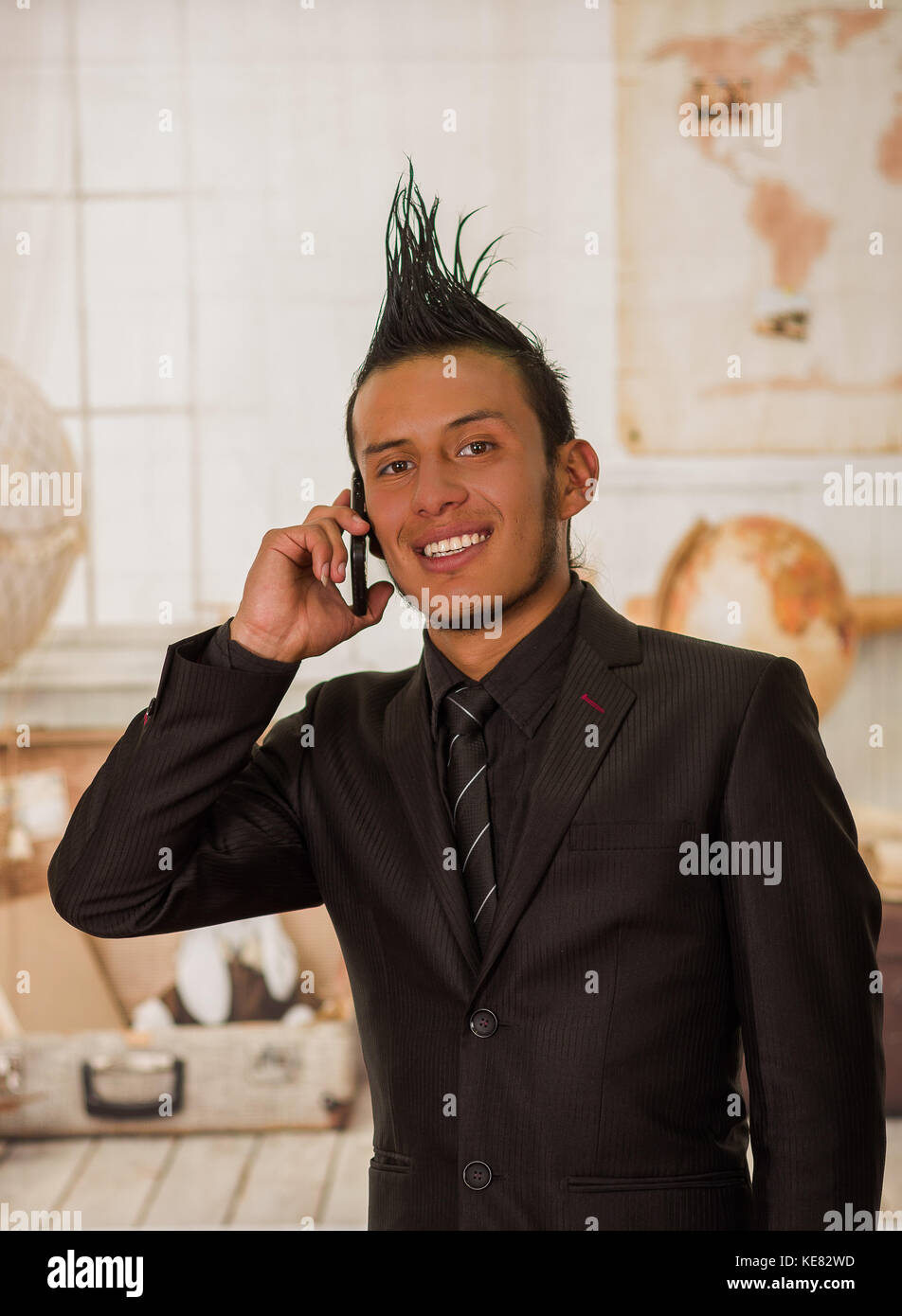Close up of happy office punk worker wearing a suit with a crest, using ...