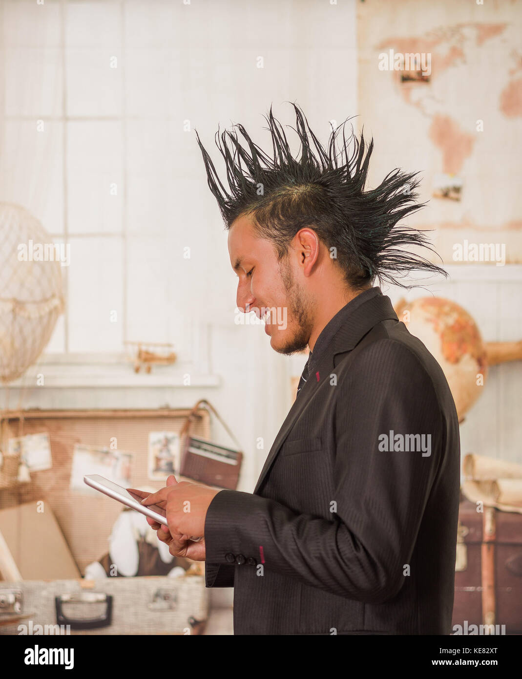 Close up of office punk man, wearing a suit with a crest, using his ...