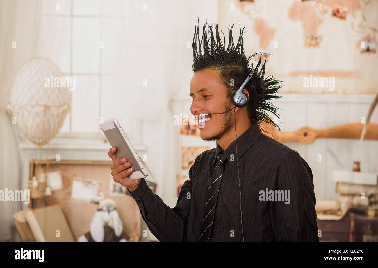 Close up of office punk man, wearing a suit with a crest, with ...
