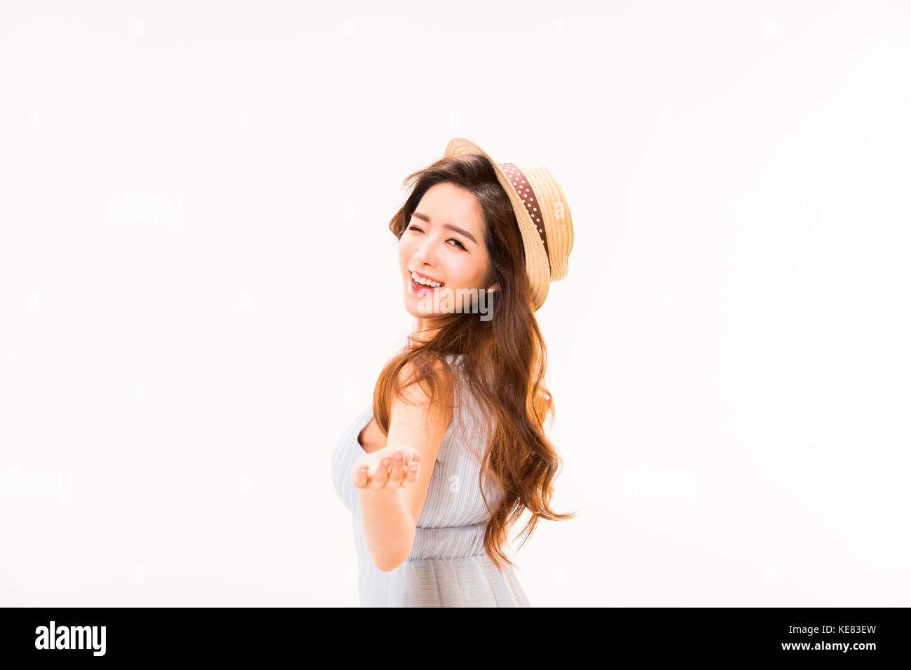 Side view portrait of young smiling woman in summer dress and hat ...