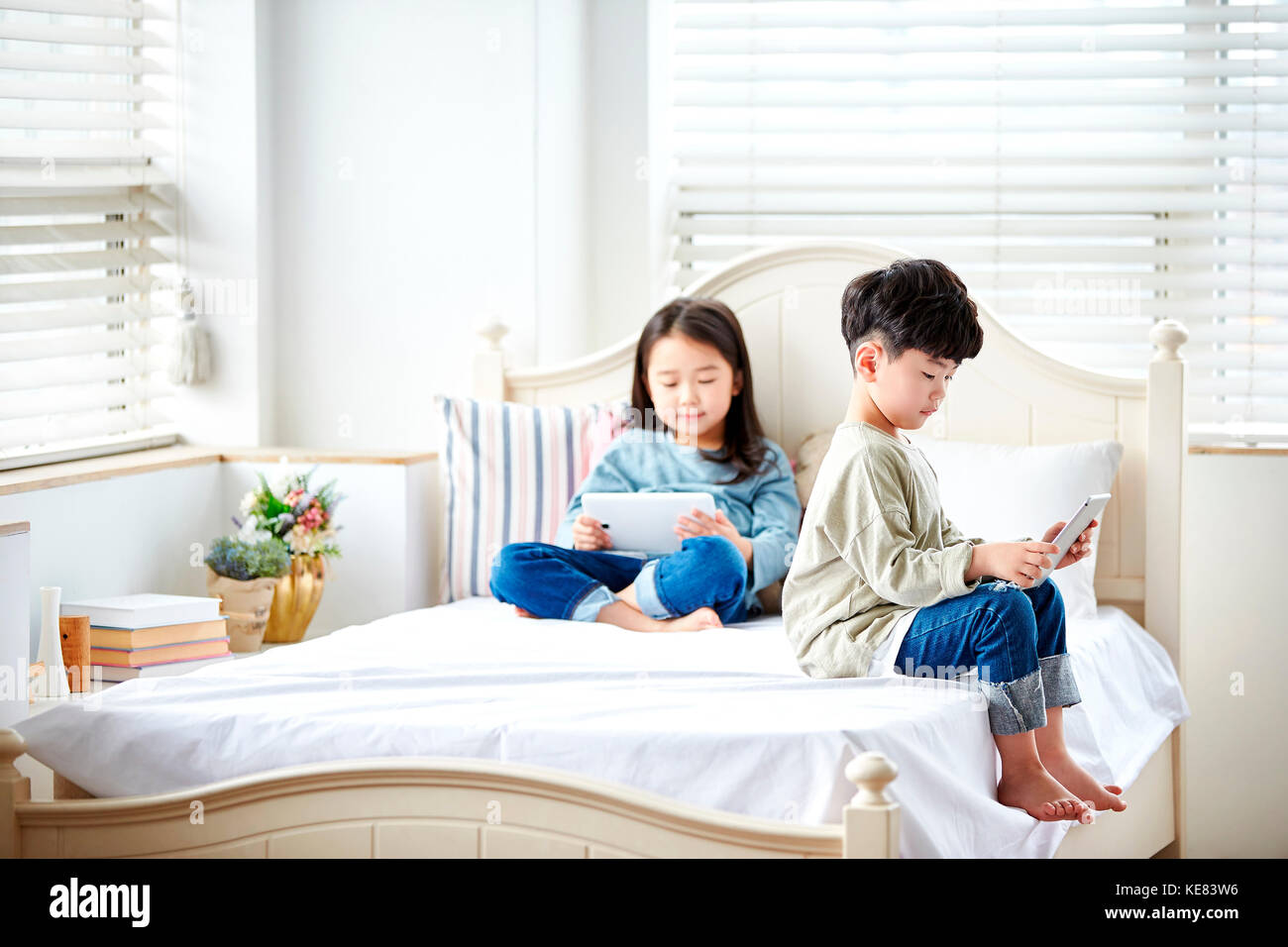 Boy girl bed tablets hi-res stock photography and images - Alamy