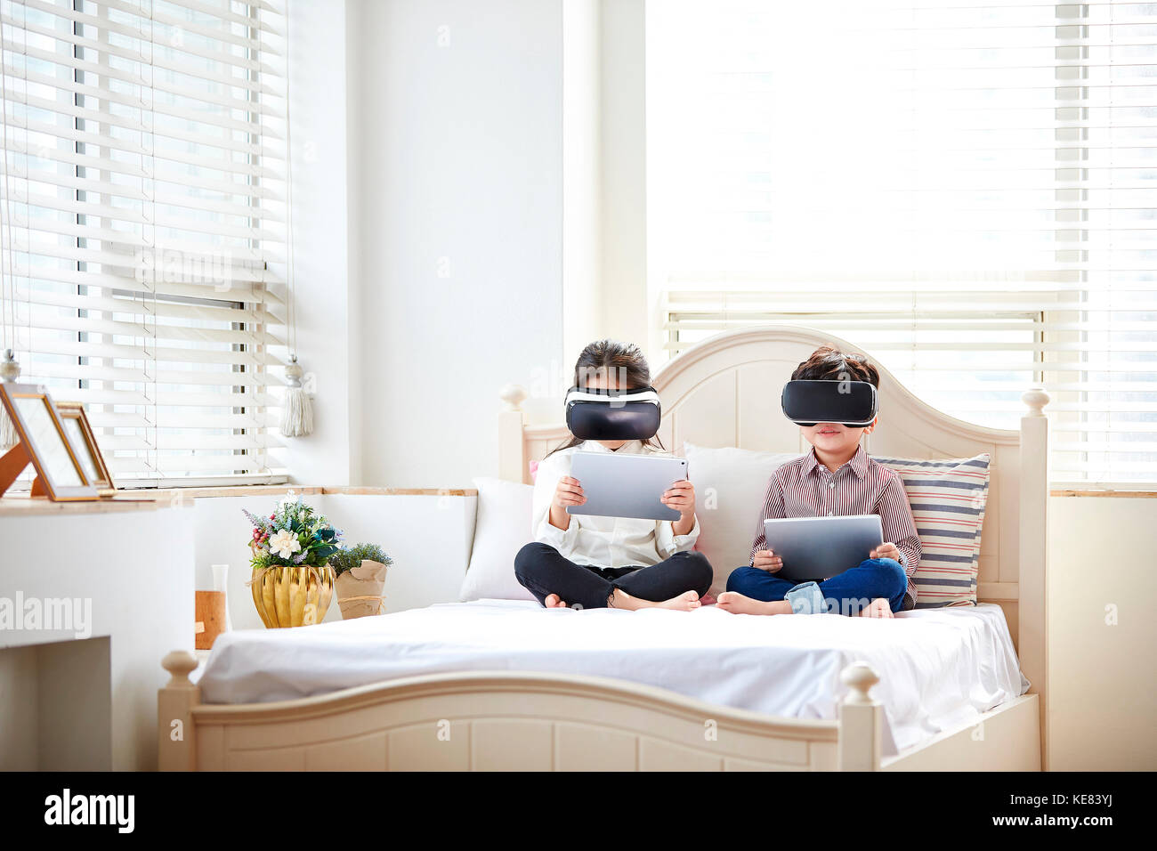 Boy girl bed tablets hi-res stock photography and images - Alamy