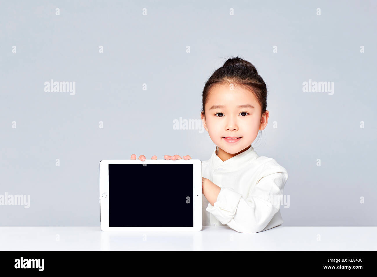 Portrait of girl showing electric tablet Stock Photo - Alamy