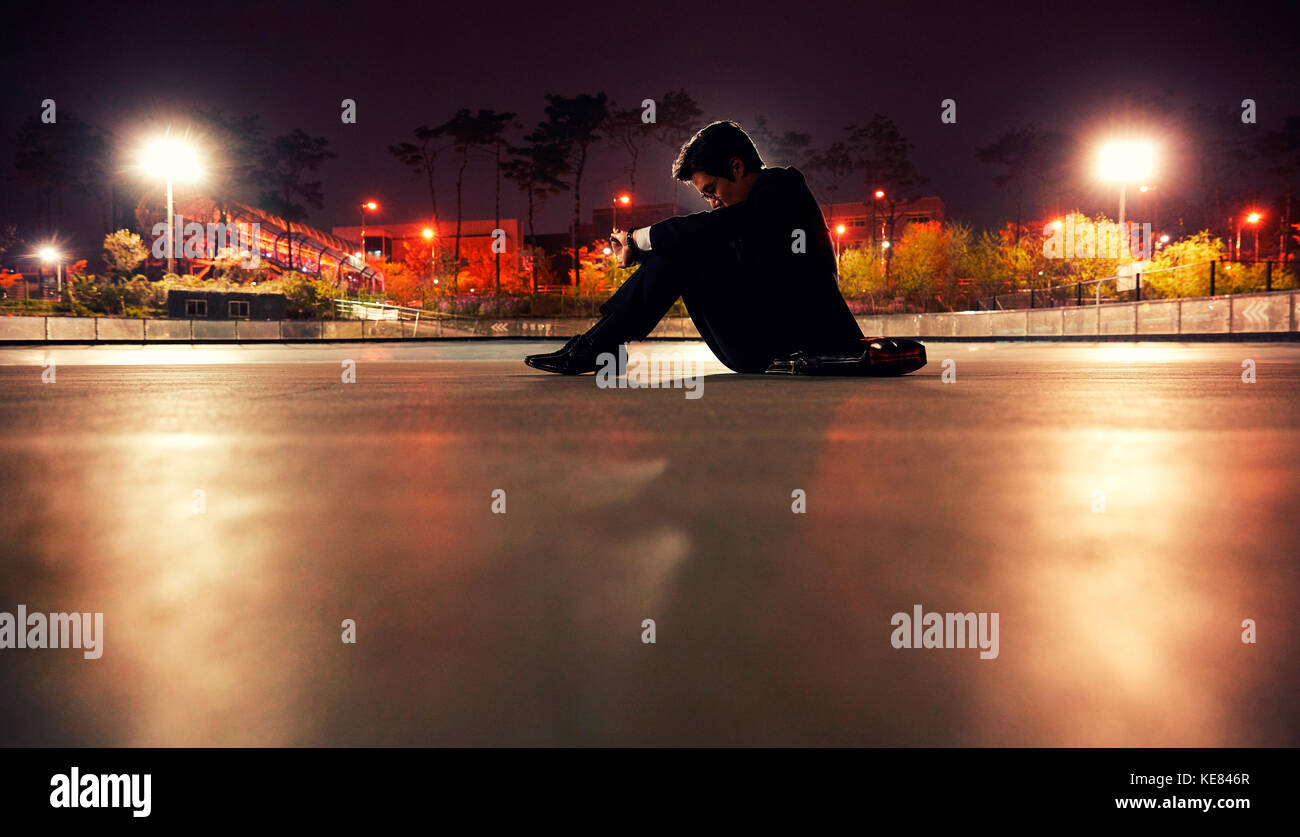 Businessman tired and gloomy at night Stock Photo - Alamy