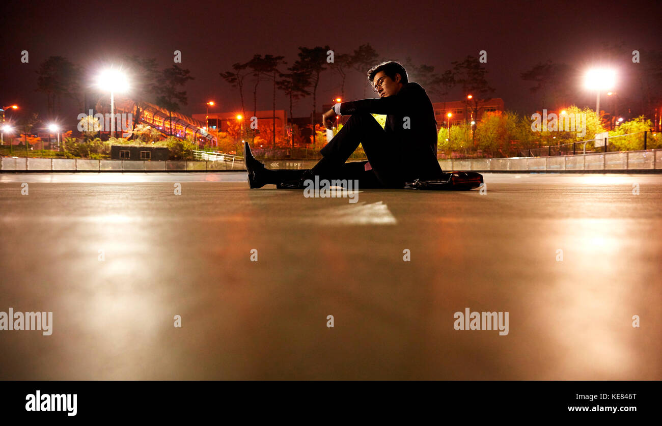 Businessman tired and gloomy at night Stock Photo - Alamy