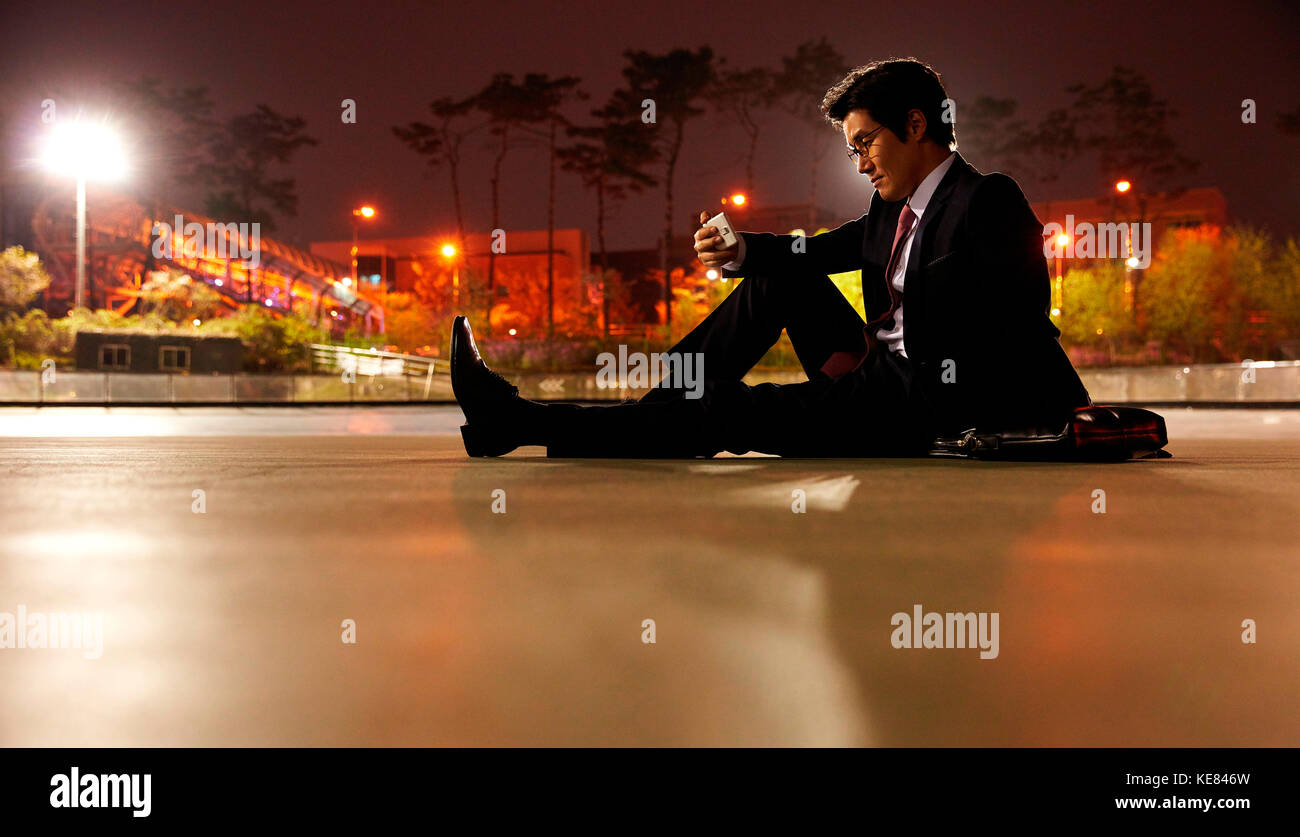 Businessman tired and gloomy at night Stock Photo - Alamy