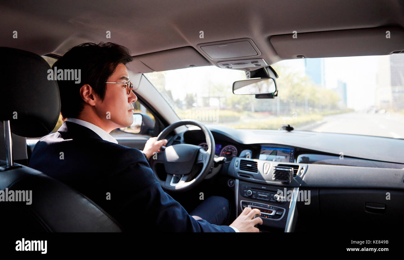 Side view portrait of businessman driving car Stock Photo - Alamy