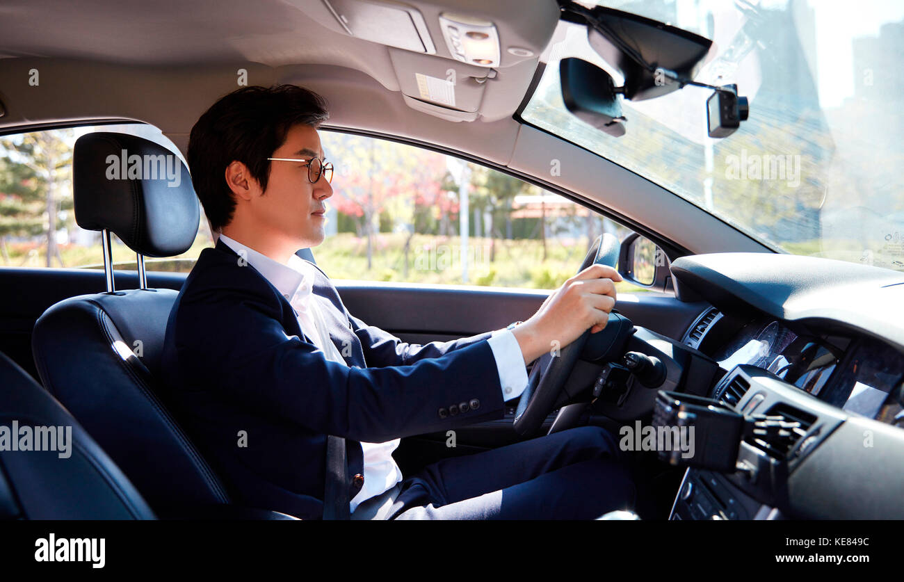 Side view portrait of businessman driving car Stock Photo - Alamy