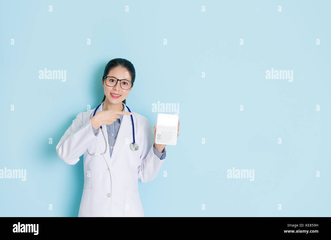 young professional female doctor face to camera smiling standing in ...