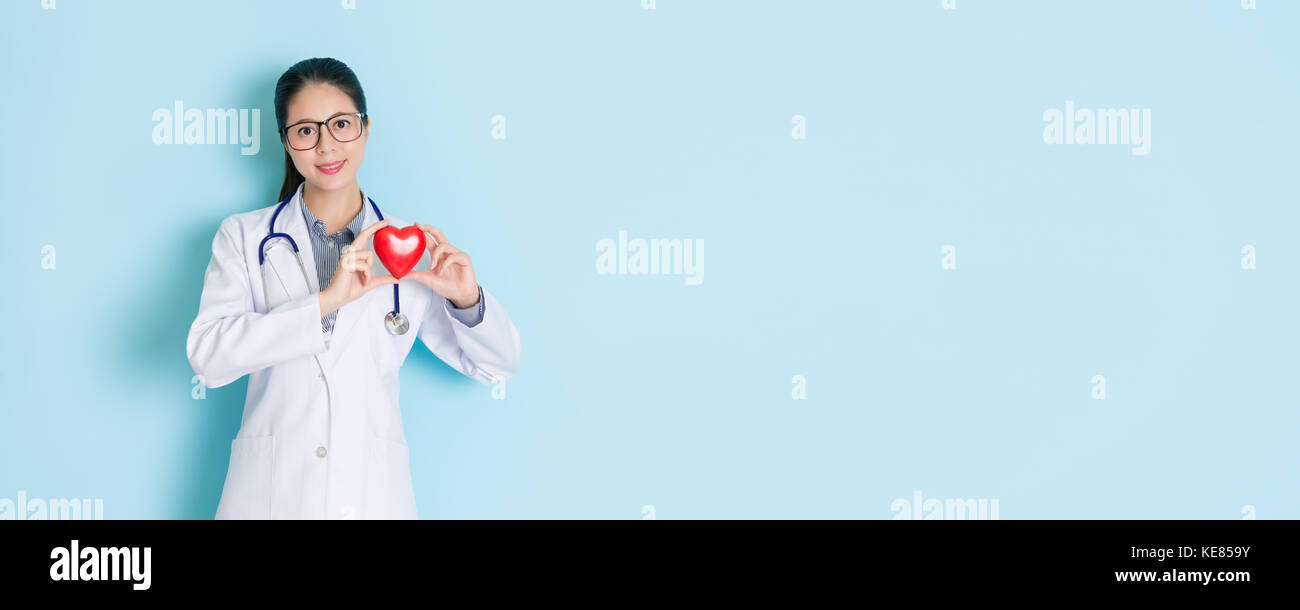 attractive beauty female cardiologist looking at camera smiling in blue ...