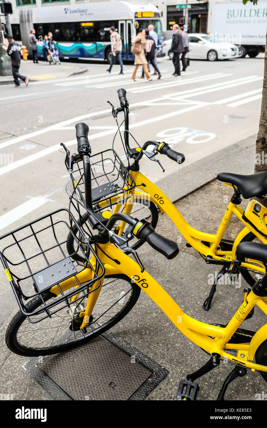 Dockless shared bikes parked by a designated bike lane at the street of ...