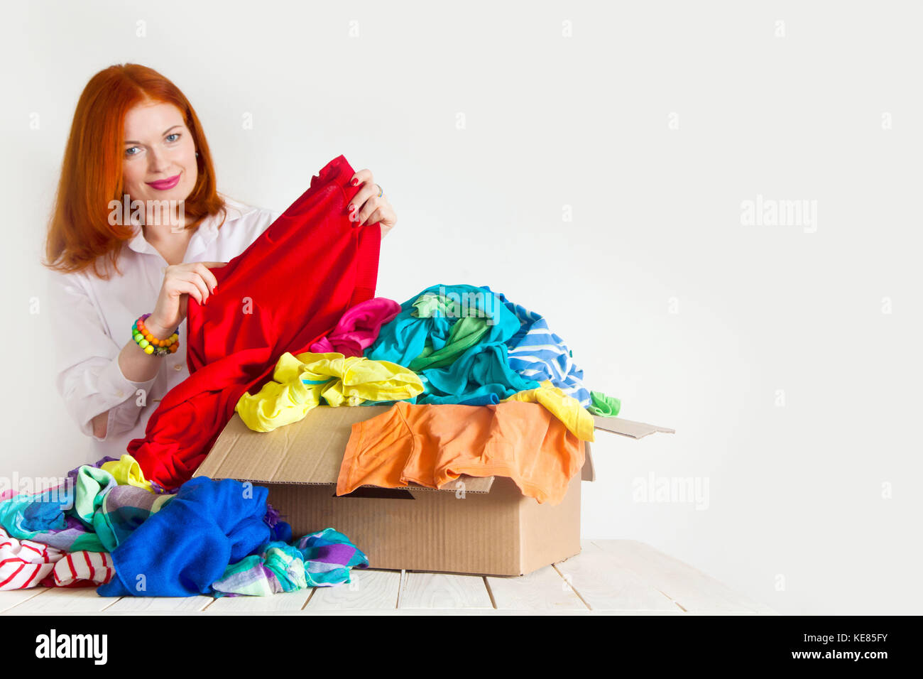 The girl chooses extra things that would throw them away. A box for ...