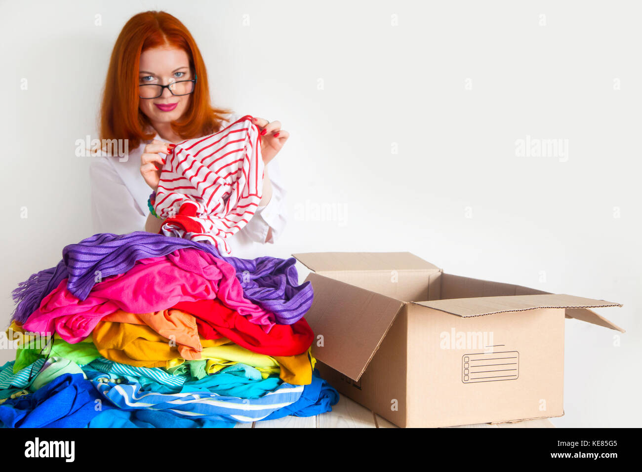 The girl chooses extra things that would throw them away. A box for ...