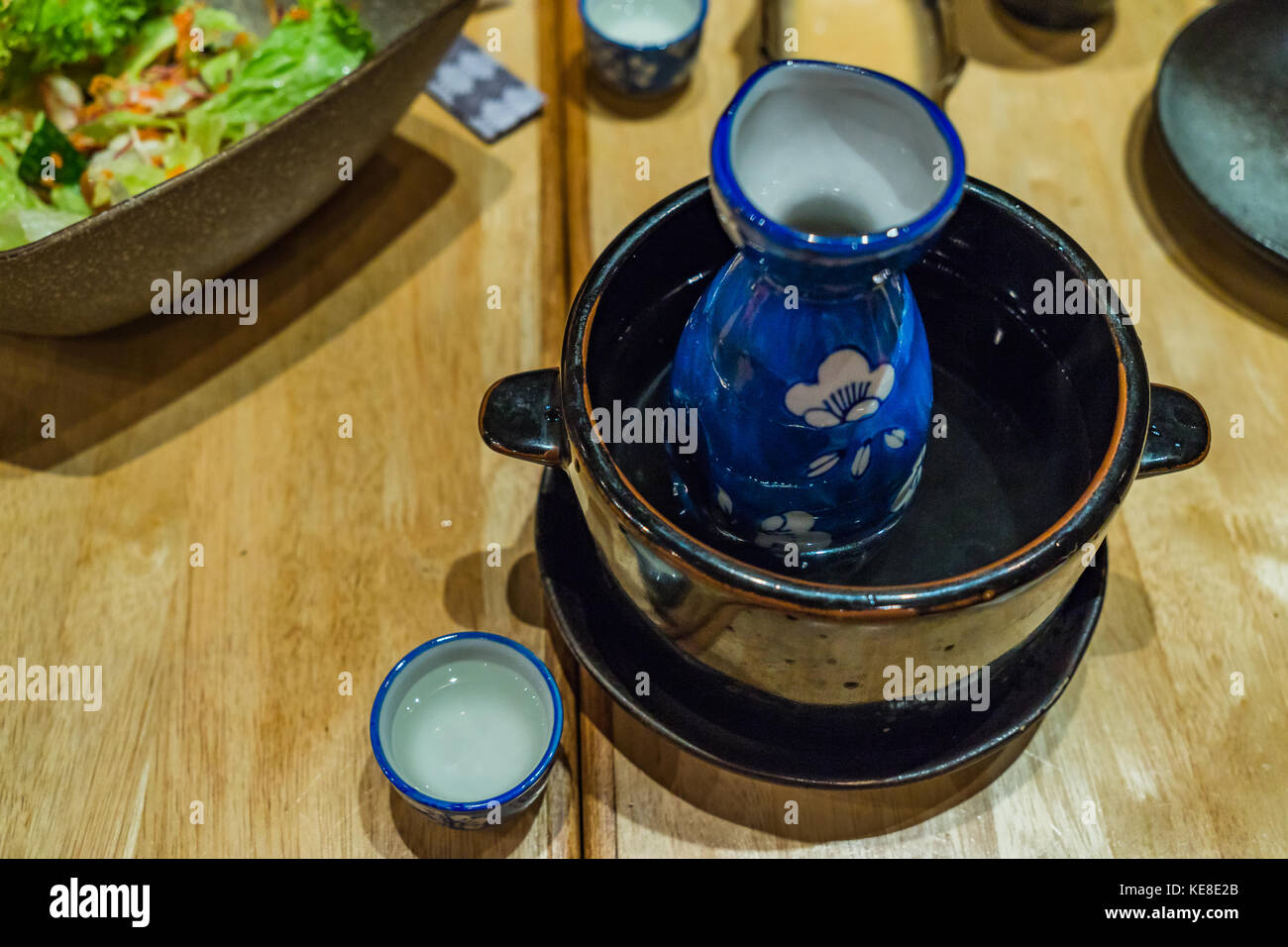 Japanese Hot Sake in hot water bowl on wooden table background Stock ...
