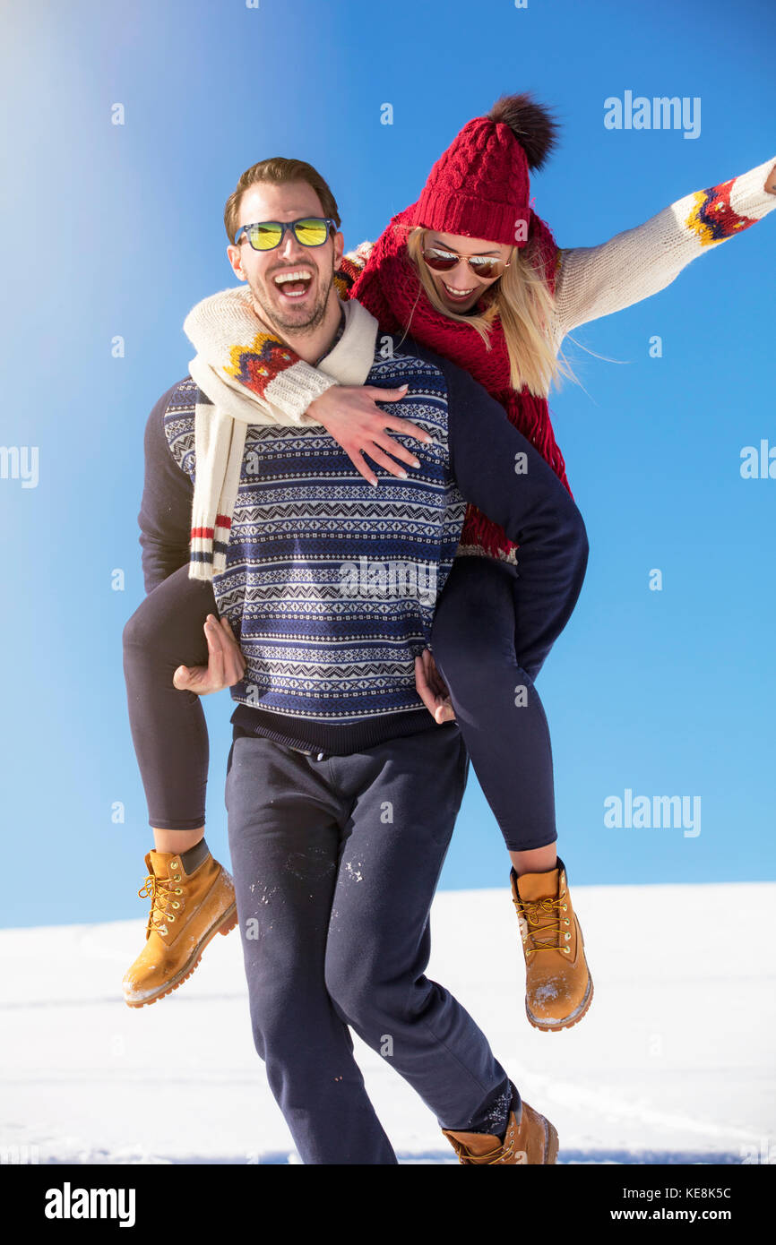 Loving couple playing together in snow outdoor Stock Photo - Alamy