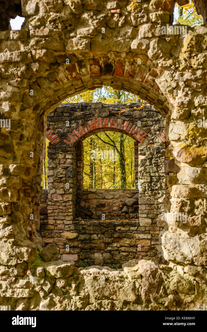 ruins of old abandoned stone brick castle in autumn with yellow colored ...