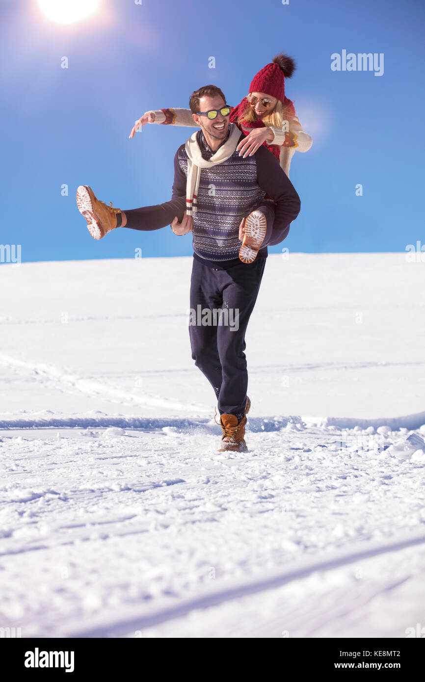 Loving couple playing together in snow outdoor Stock Photo - Alamy