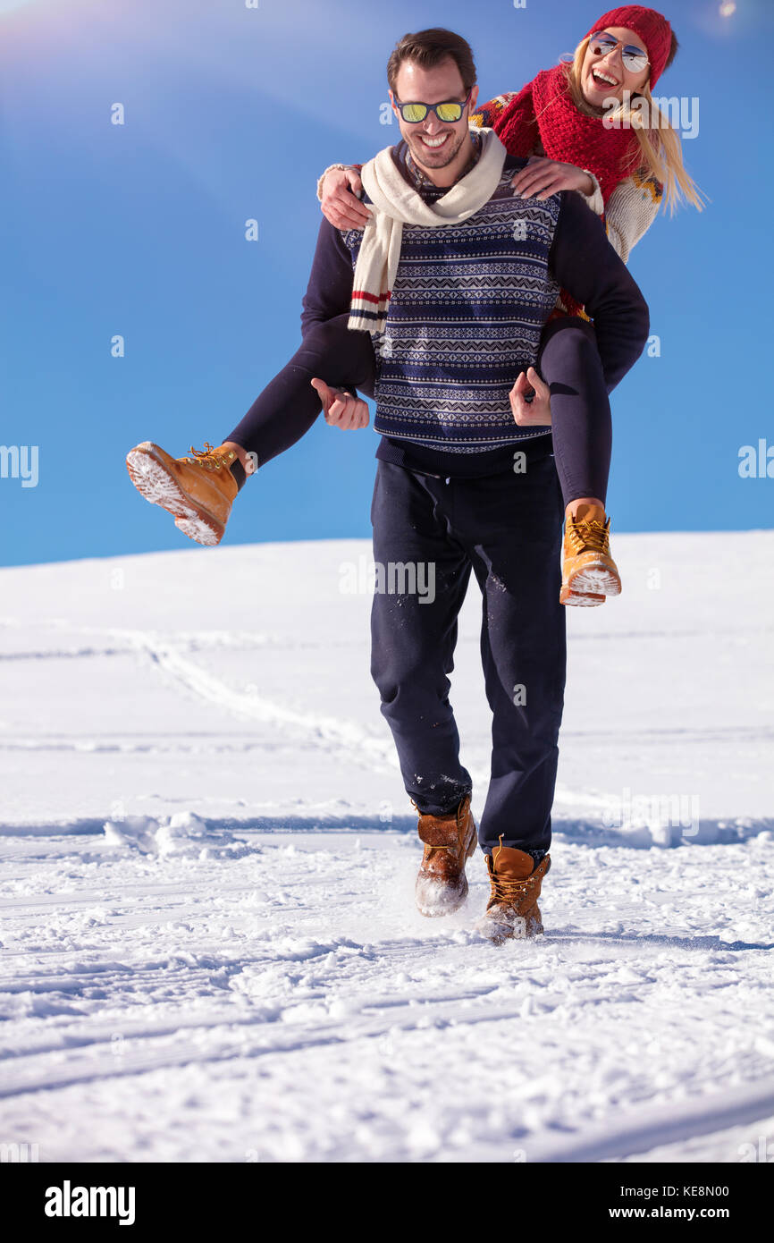 Loving couple playing together in snow outdoor Stock Photo - Alamy
