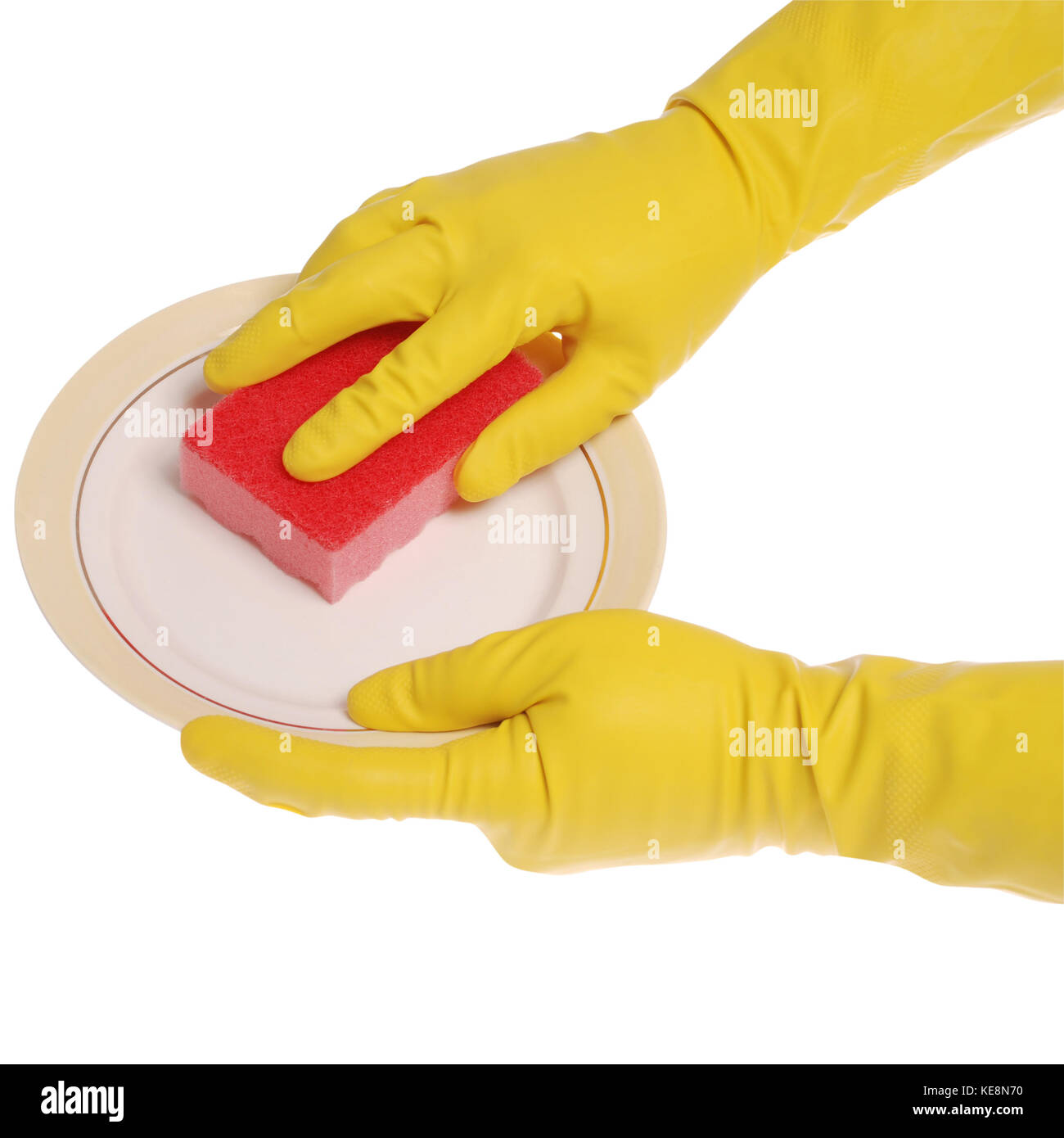 Yellow gloved hands washing a plate with a red sponge. On white ...
