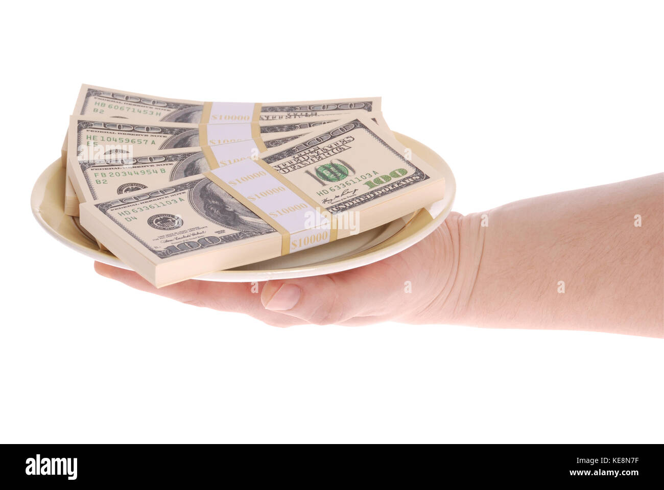 Money on plate with hand. Isolated on white. Clipping path included ...