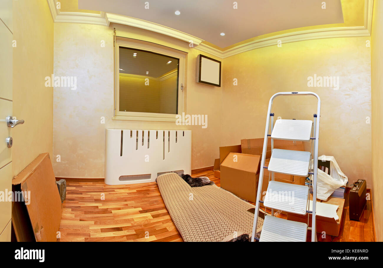 Moving In Into New Apartment With Packed Cardboard Boxes Stock Photo