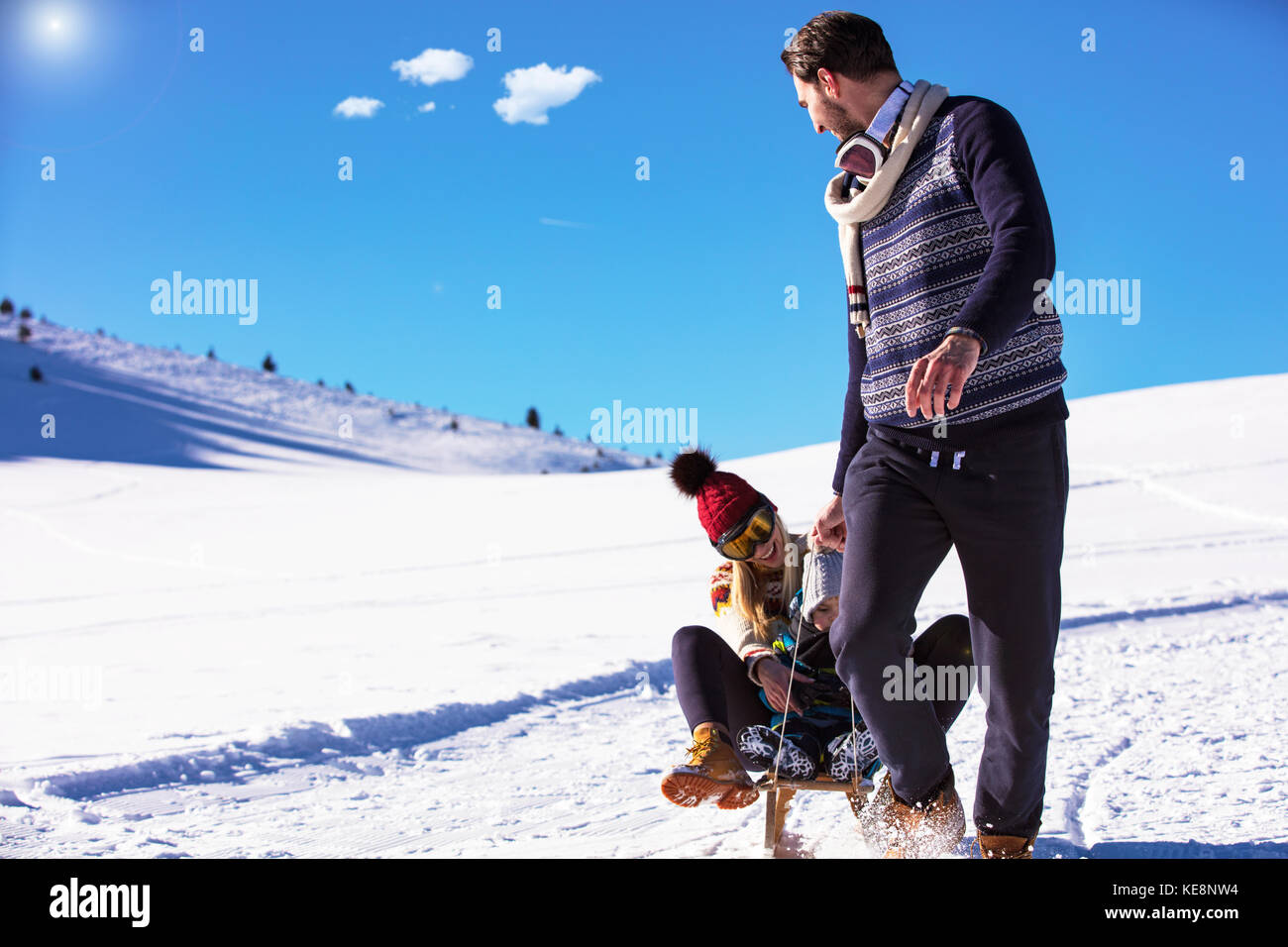 the happy family rides the sledge in the winter wood, cheerful winter ...