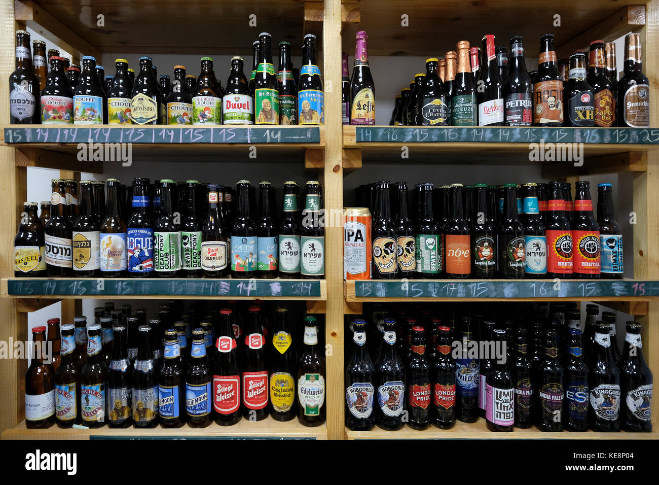 Different beer bottles lined up in a Beer and Spirits Store Stock Photo ...