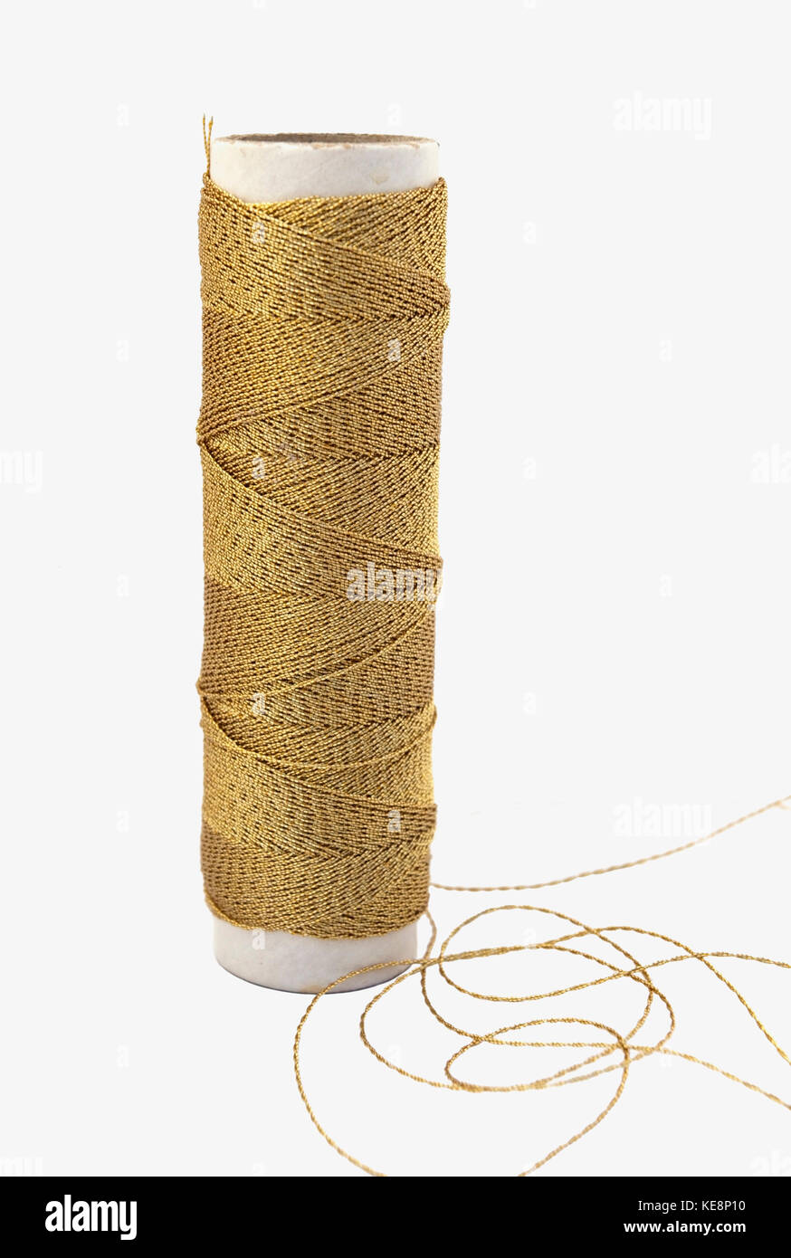 Spool of isolated gold thread. Vertical Stock Photo - Alamy