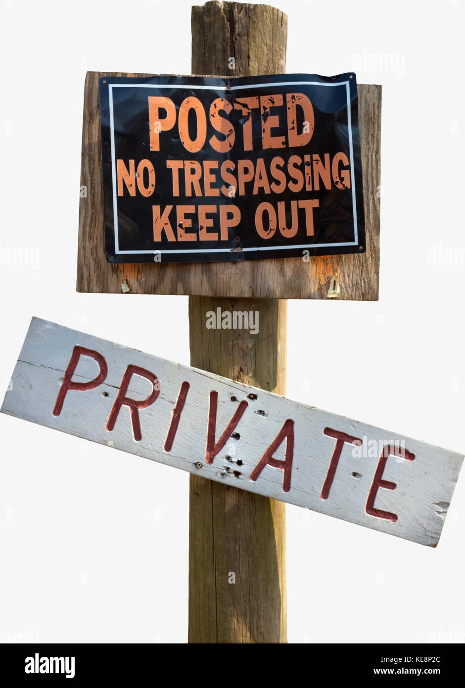 POSTED NO TRESPASSING KEEP OUT PRIVATE sign on wood pole. Isolated ...