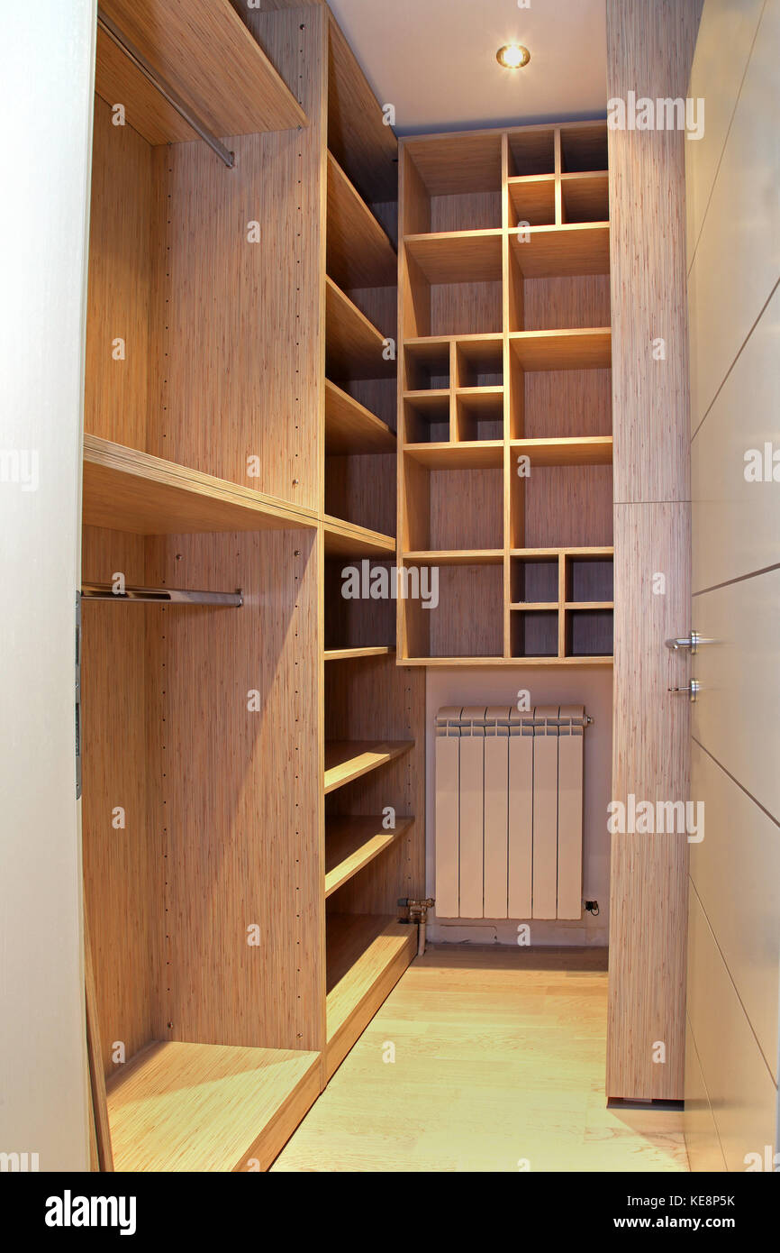 Empty walk in closet with wooden shelves Stock Photo - Alamy