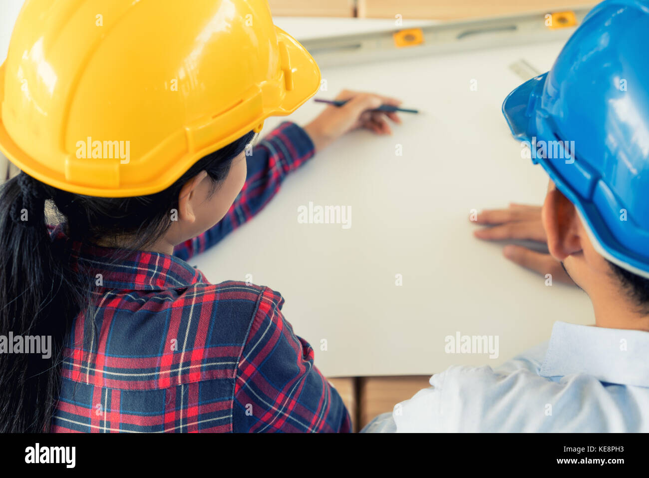 Couple of young engineers or architects working in the office ...
