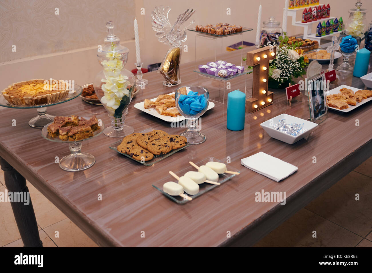 Sweets table for guests at baptism party Stock Photo - Alamy