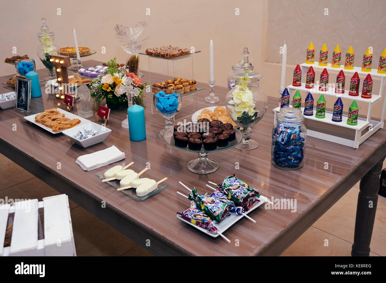 Sweets table for guests at baptism party Stock Photo - Alamy