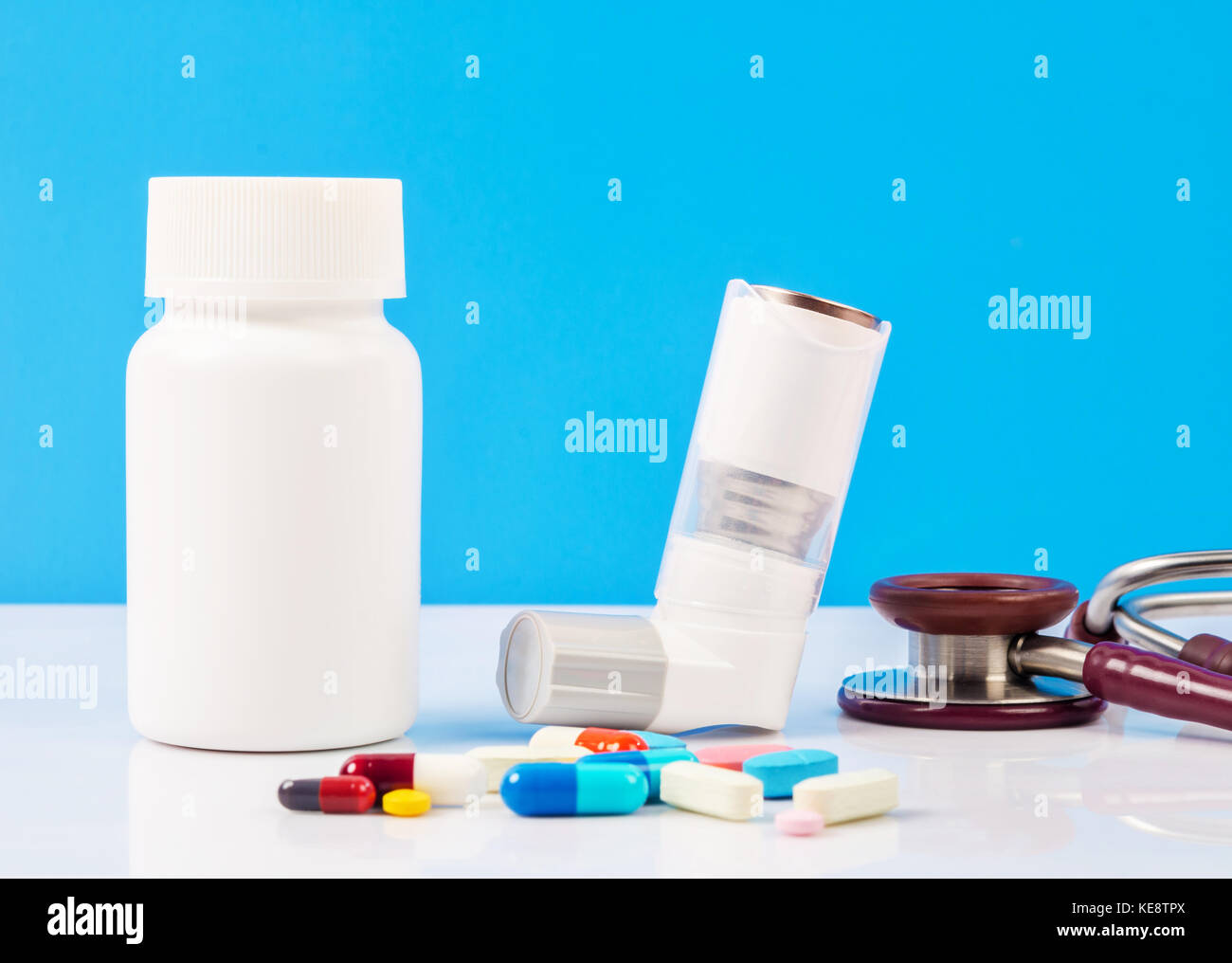 Asthma inhaler with pills and stethoscope medical Stock Photo - Alamy