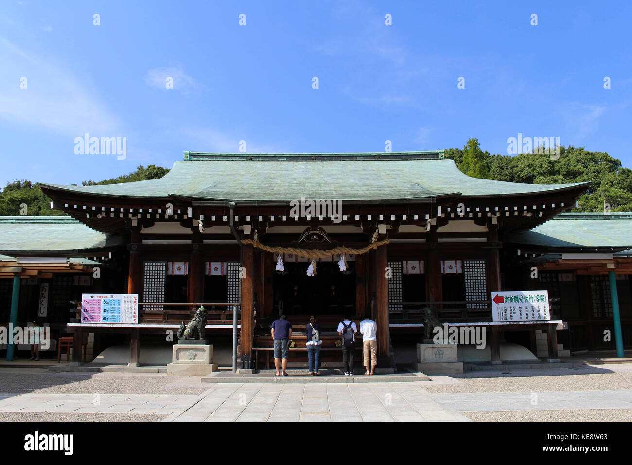 People praying in front of wooden Japanese temple in Yamaguchi ...