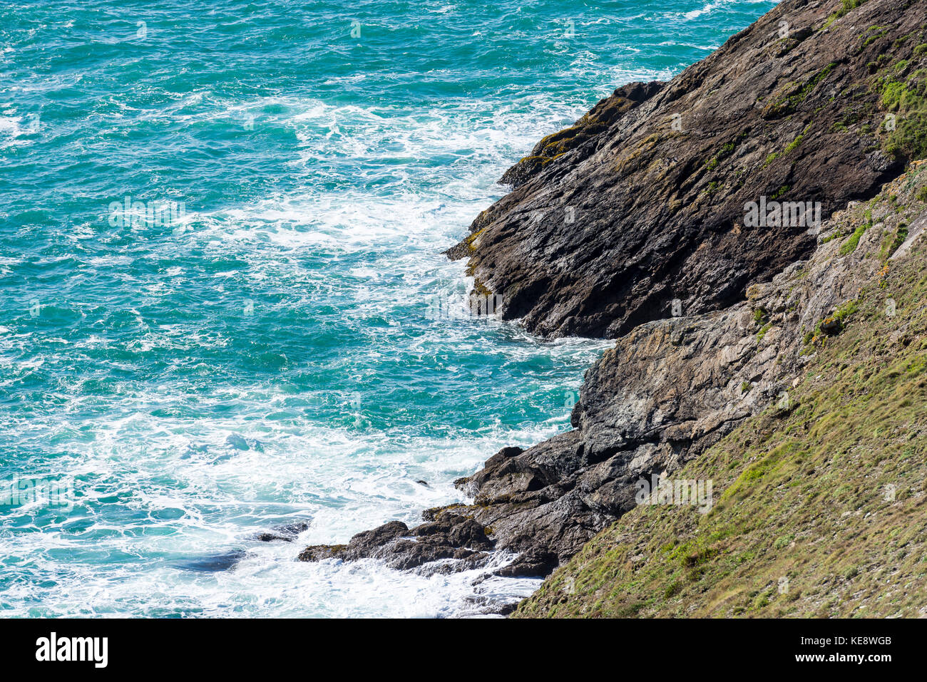 Waves crash against the rocky shoreline of the North Cornwall coast ...