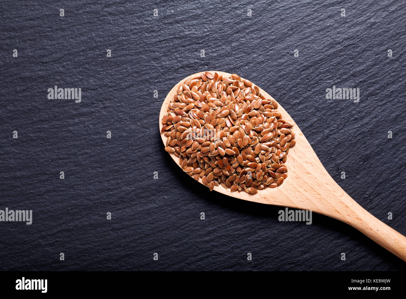 Organic Flax seeds on black slate stone plate Stock Photo - Alamy