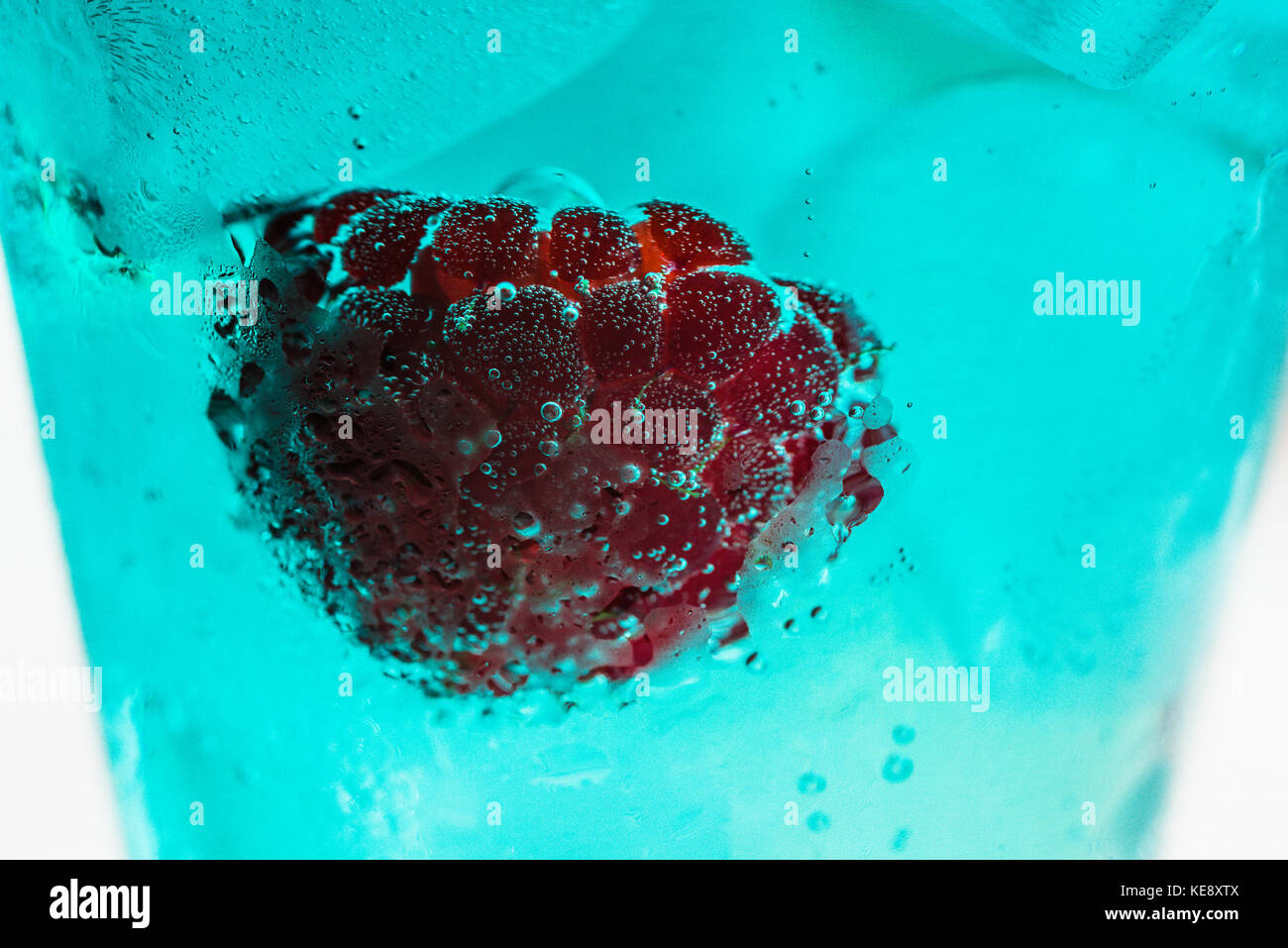 Raspberry in blue cool liquid Stock Photo - Alamy