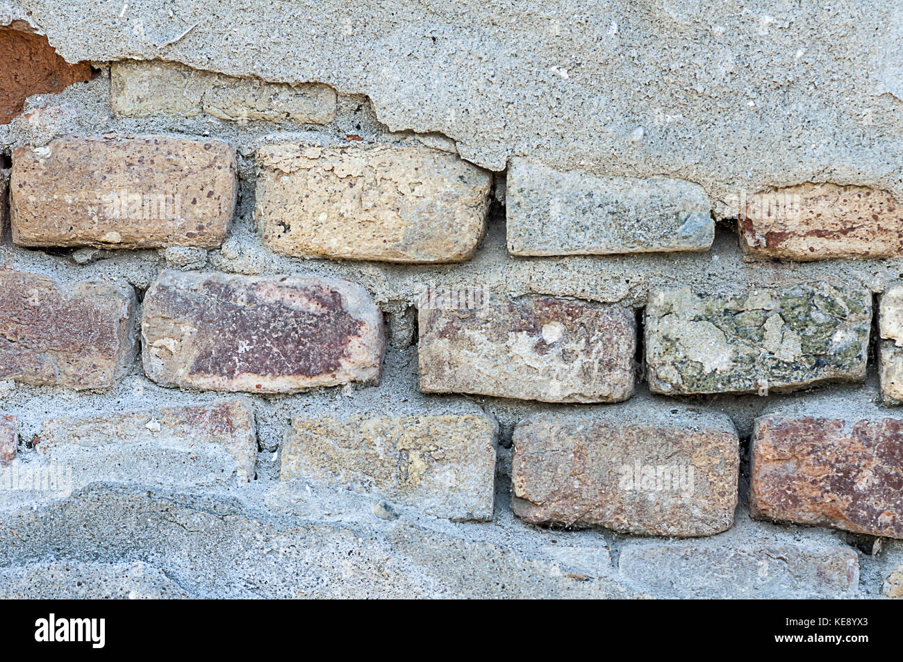 Brick wall. Broken plaster. Cracked and corroded cement Stock Photo - Alamy